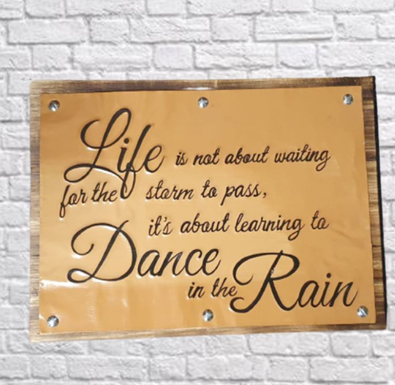 wooden and tin dance in the rain sign